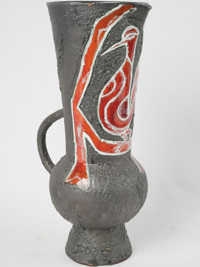 Large French volcanic black ceramic pitcher w/ red-glazed woodpecker d