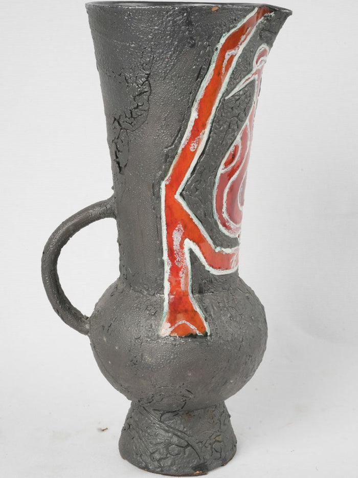Large French volcanic black ceramic pitcher w/ red-glazed woodpecker d