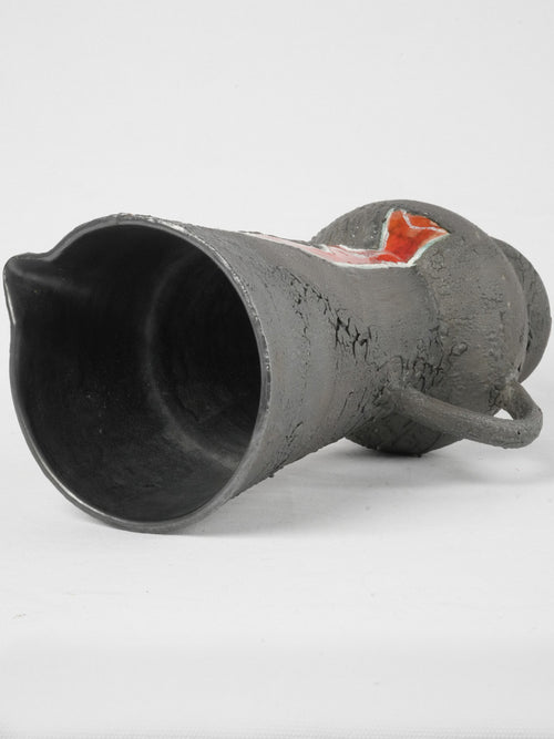 Large French volcanic black ceramic pitcher w/ red-glazed woodpecker d