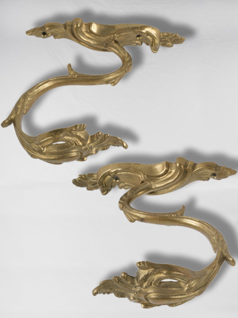Pair of molded brass curtain hooks w/ scrolling acanthus leaves