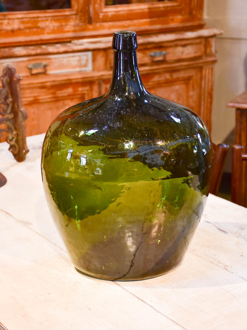 Large oval demijohn with dark green glass – Chez Pluie