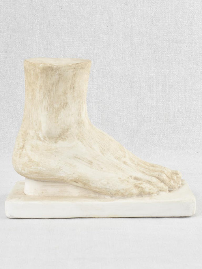 Vintage plaster foot sculpture mounted on a rectangular base