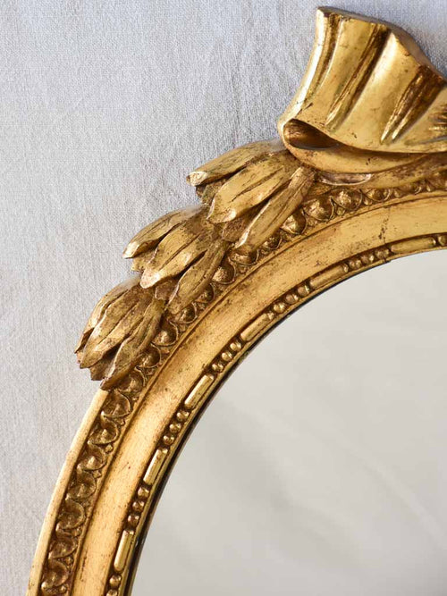 Louis XVI style oval mirror with large bow pediment 20¾" x 28¾"