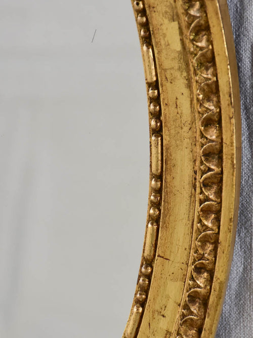 Louis XVI style oval mirror with large bow pediment 20¾" x 28¾"
